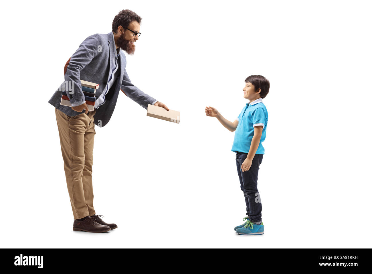Full length profile shot of a male teacher giving a book to a boy ...