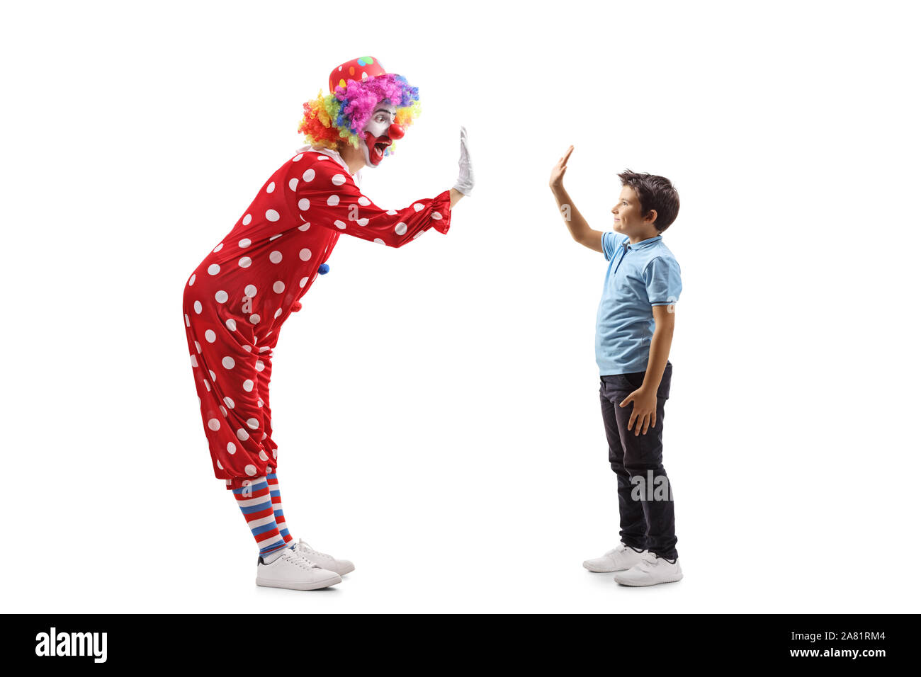 Full length profile shot of a clown making high-five gesture with a ...