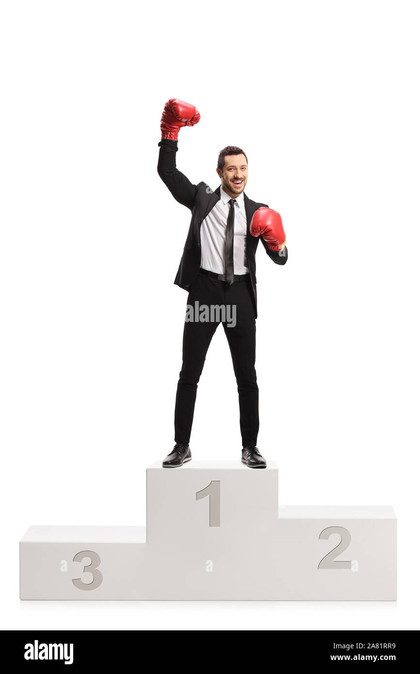 Full length portrait of a man in a suit with boxing gloves posing on a ...