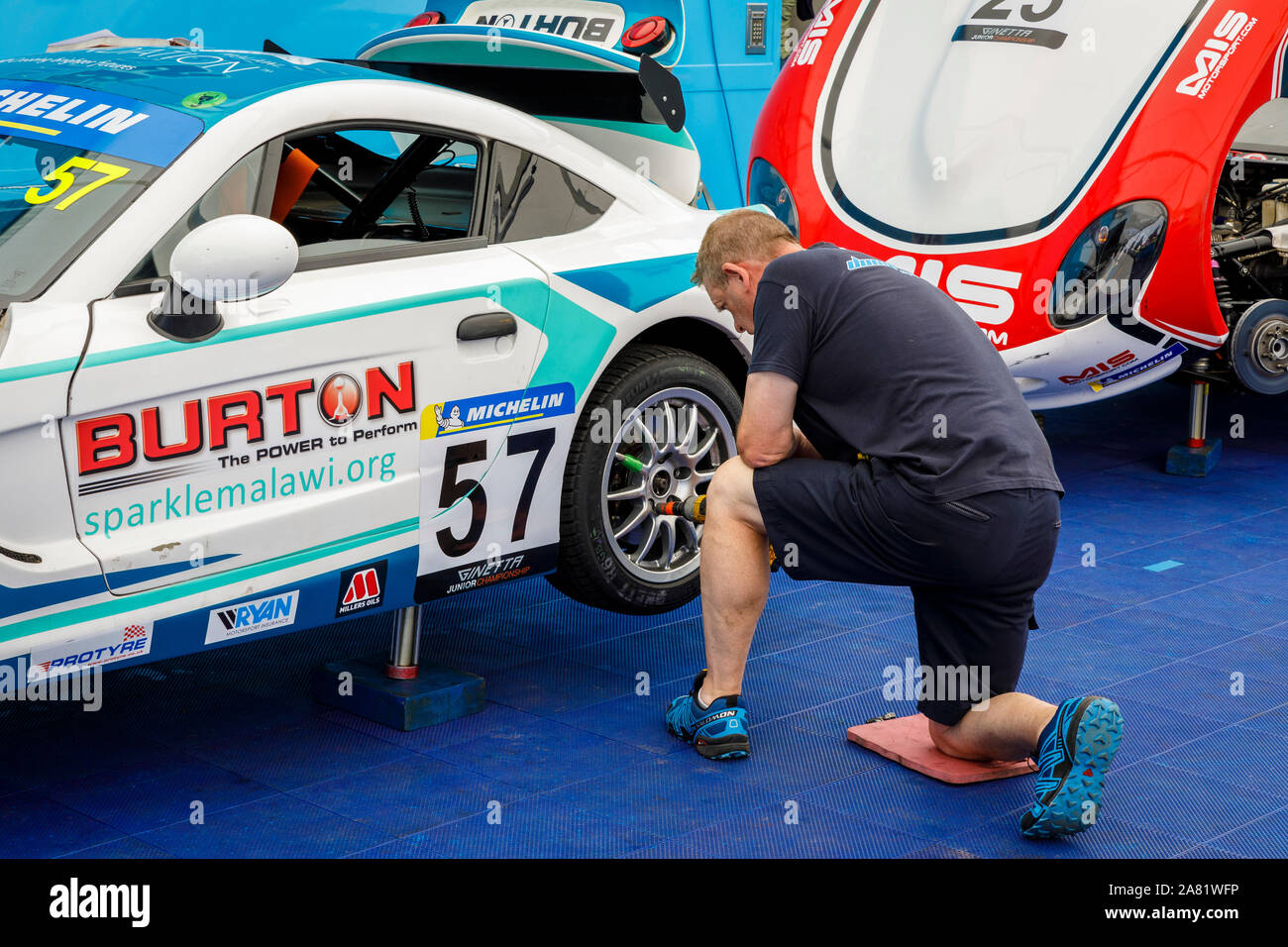 Mechanic at work on the Douglas Motorsport Ginetta Junior car of Gus ...
