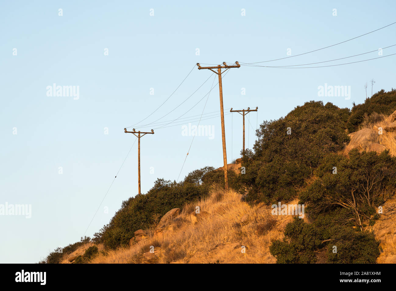 Old rural power lines above dry brush hillside near Los Angeles and ...