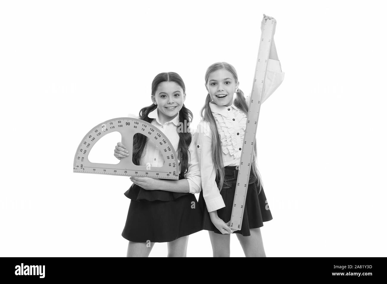 Being ready for lesson. Cute schoolgirls holding protractor and ruler ...