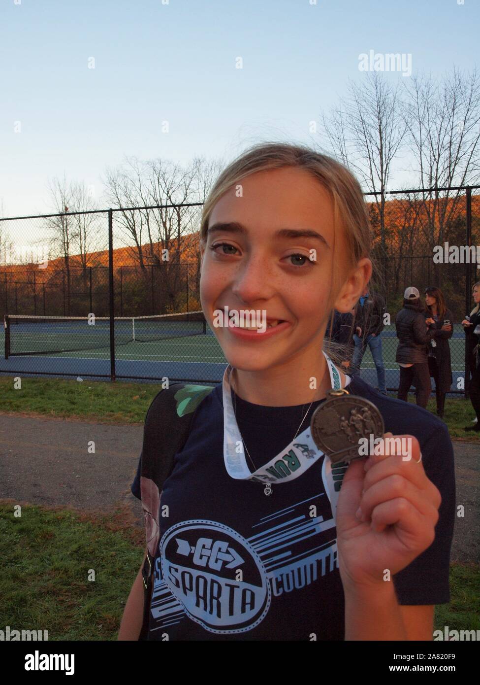 Eleven year old girl showing off her first place medal in a recent ...