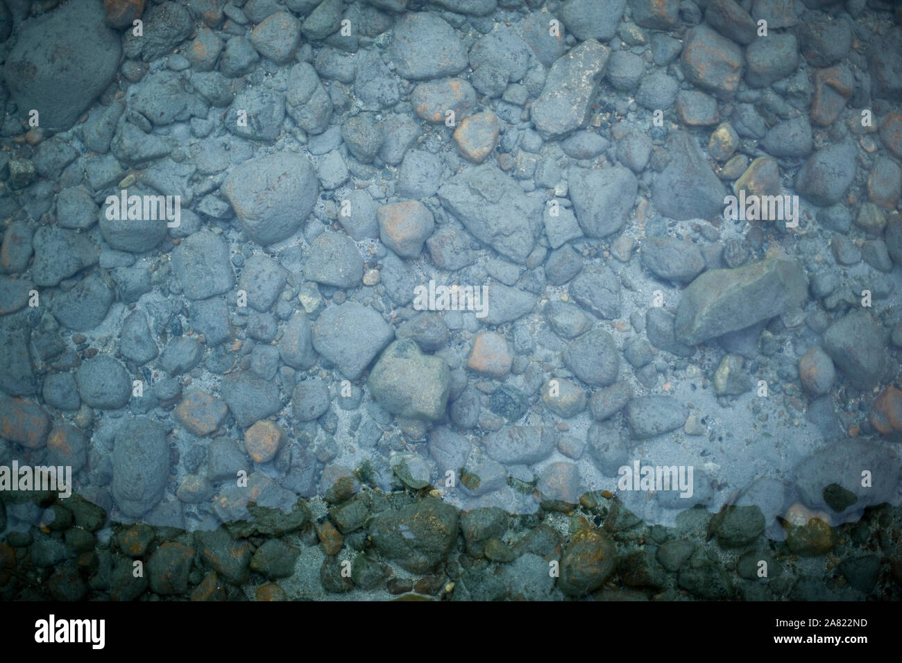 Pebbles immersed in water Stock Photo - Alamy