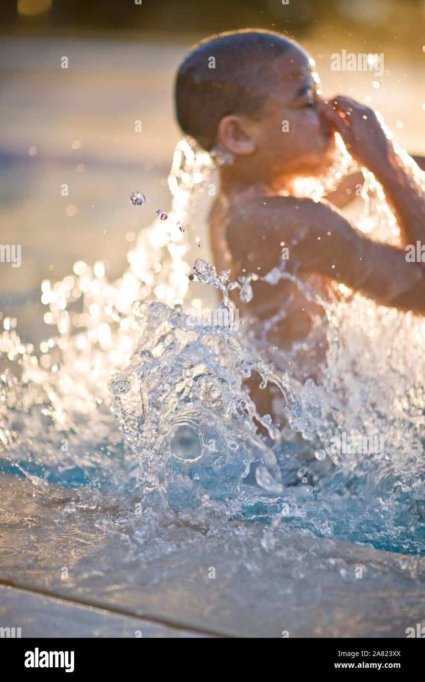 Boy jumping into pool Stock Photo - Alamy