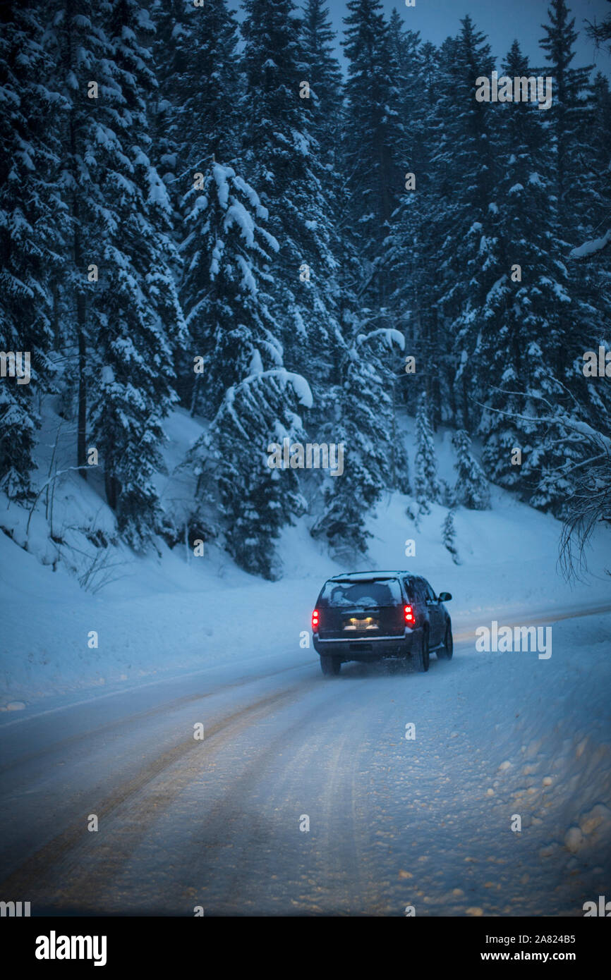 Car driving on a snow covered road at night Stock Photo - Alamy