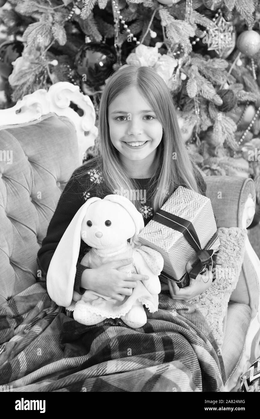 Its so cuddly and soft. Small child happy smiling with presents. Little ...