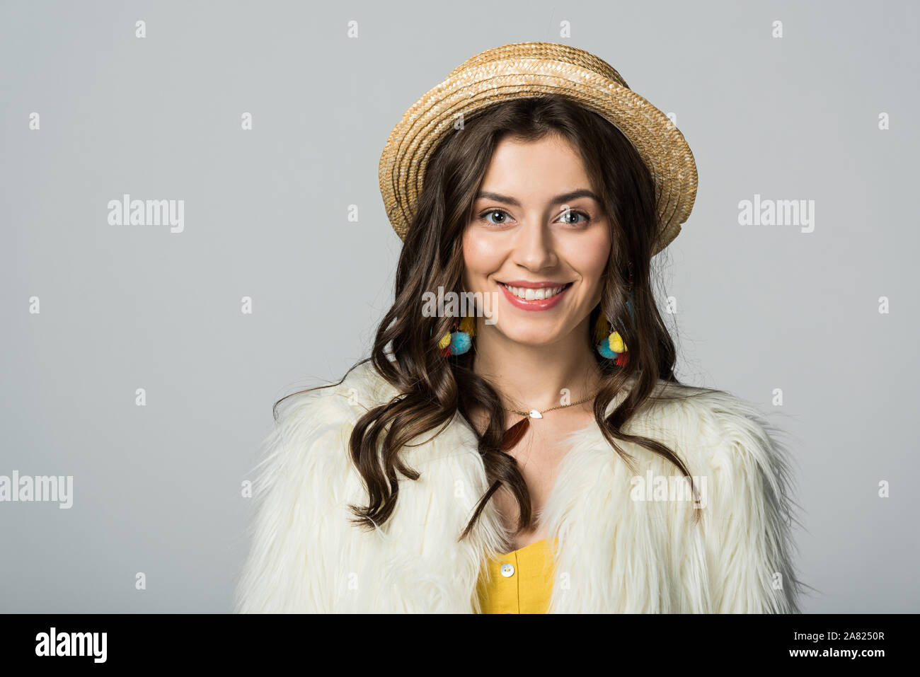 front view of attractive hobo girl in straw hat smiling isolated on ...