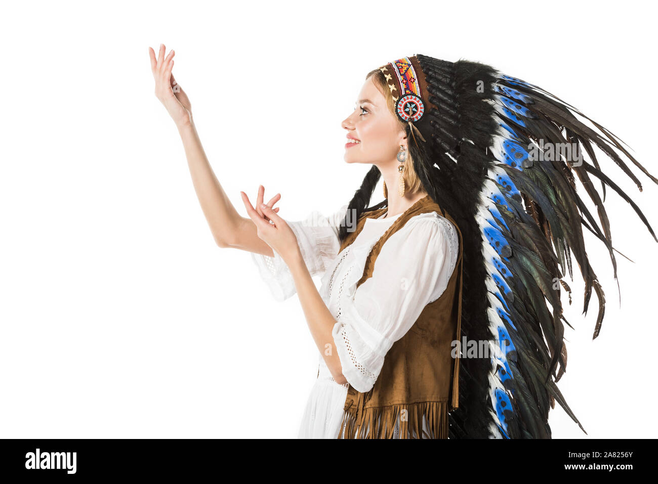side view of pretty boho girl in indian headdress isolated on white ...