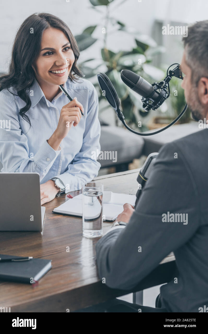 Attractive cheerful radio host interviewing hi-res stock photography ...