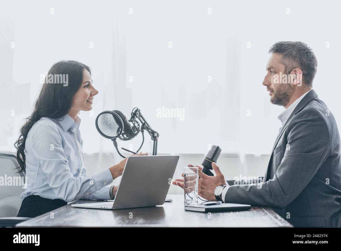 handsome businessman talking to pretty radio host during interview in ...