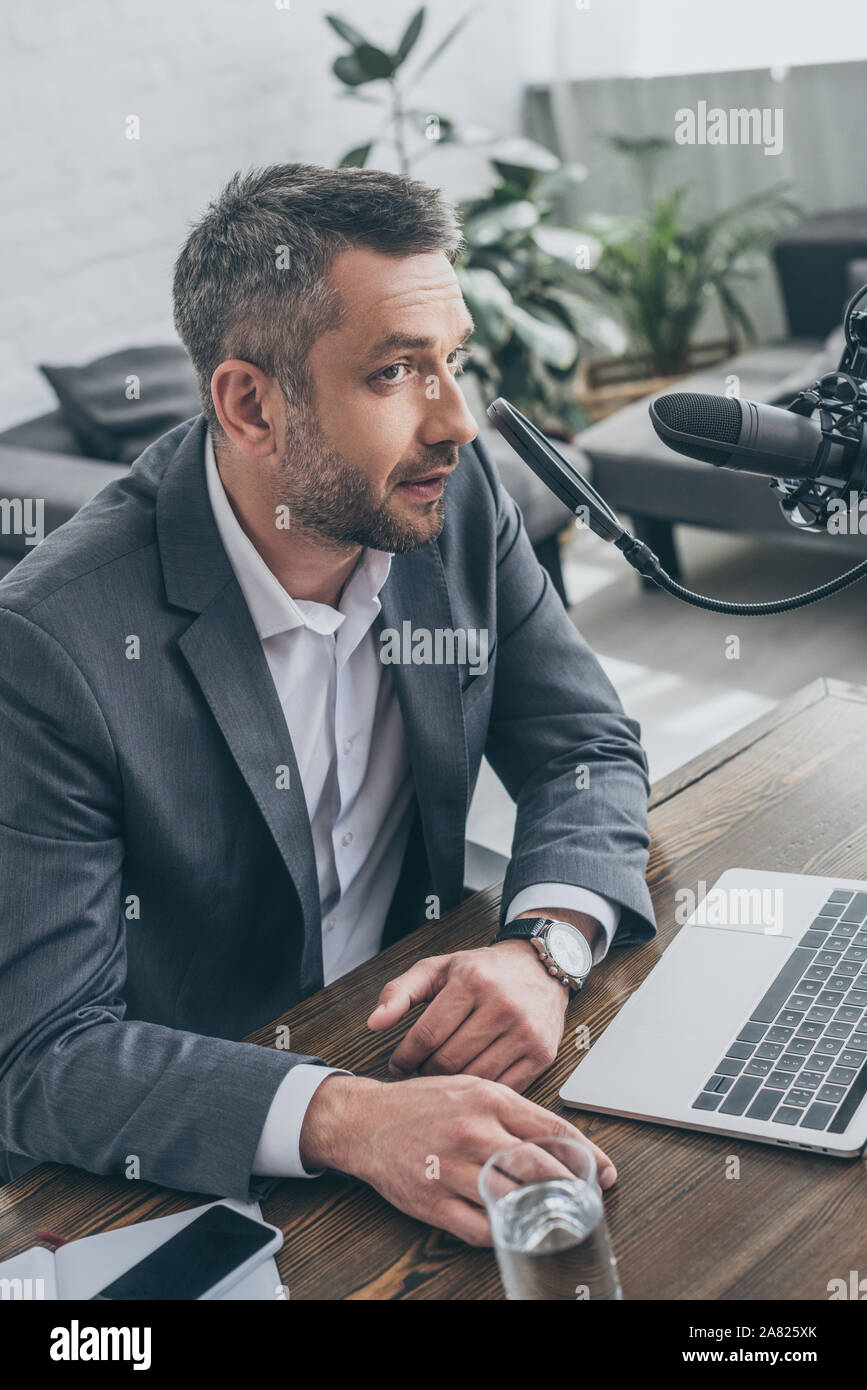 Radio host speaking into microphone hi-res stock photography and images ...