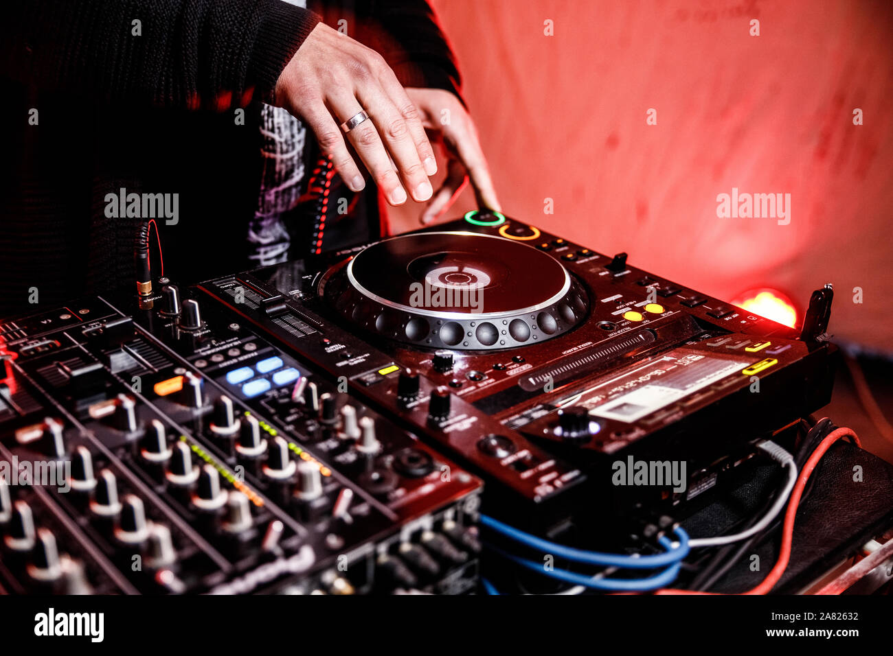 DJ plays live set and mixing music on turntable console at stage in the ...