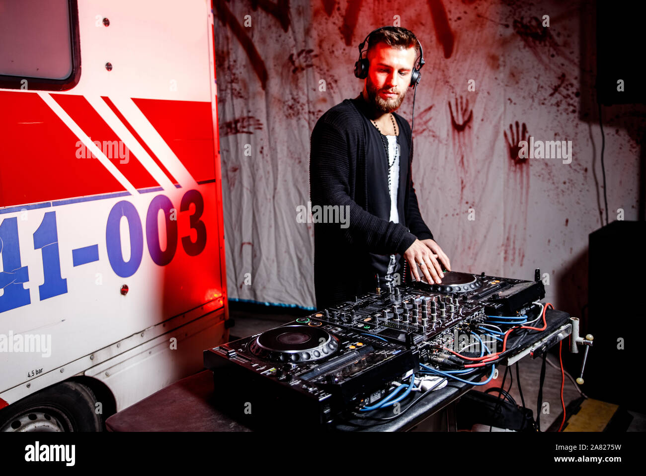 DJ plays live set and mixing music on turntable console at stage in the ...