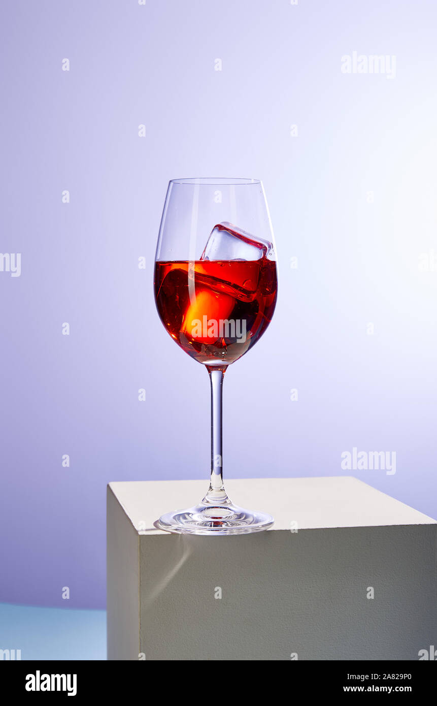 cocktail Aperol Spritz with ice cubes in glass on purple background ...