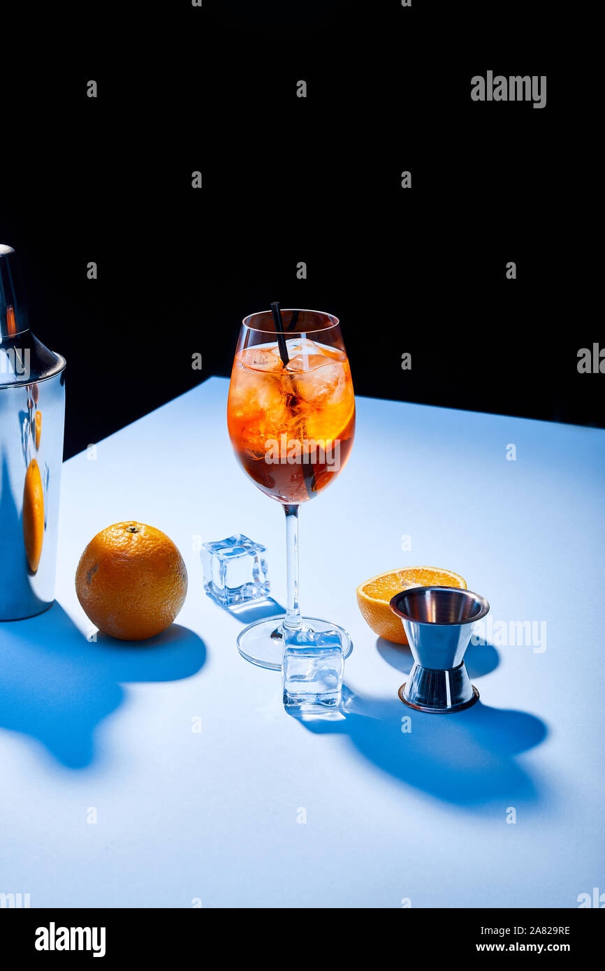 cocktail Aperol Spritz, oranges, shaker, ice cubes and measuring cup ...