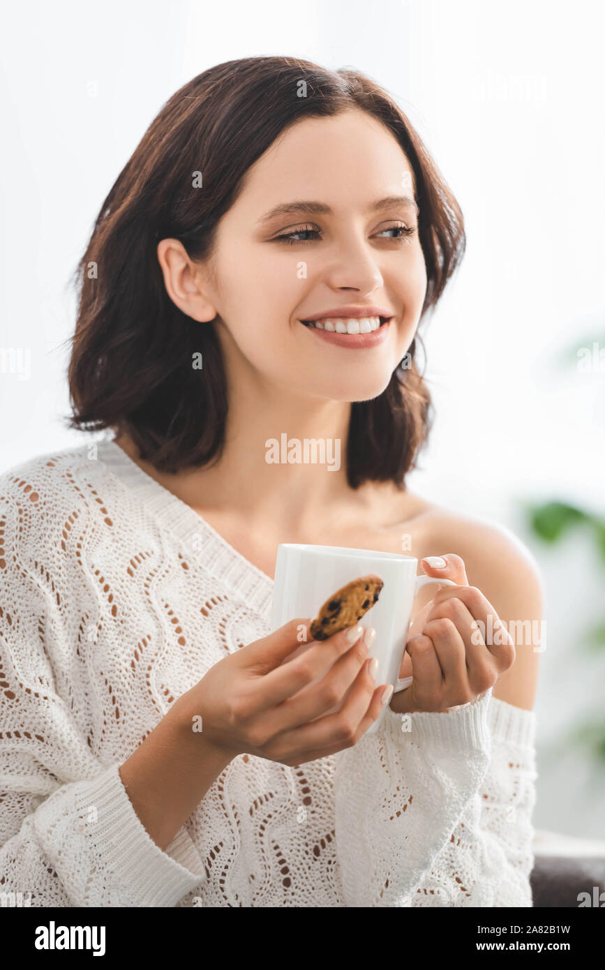 beautiful smiling girl drinking tea with cookie Stock Photo - Alamy