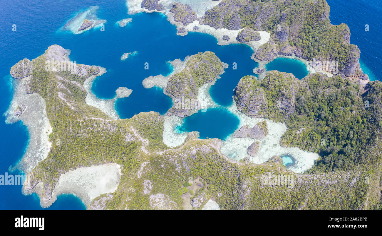 Highly eroded limestone islands rise from the beautiful, tropical ...