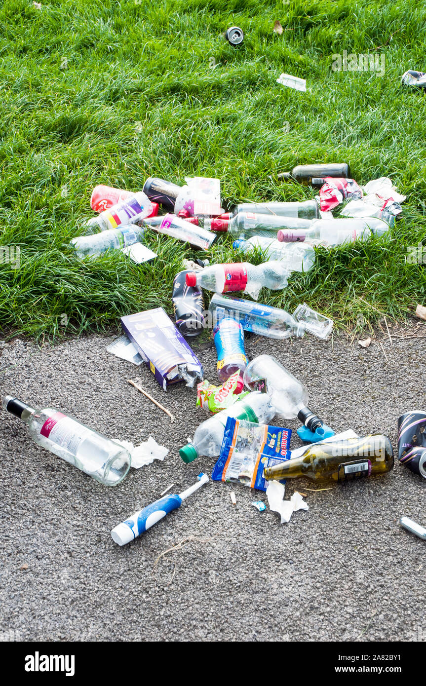 Enviromental litter or rubbish thrown on the ground. Glass bottles tin ...