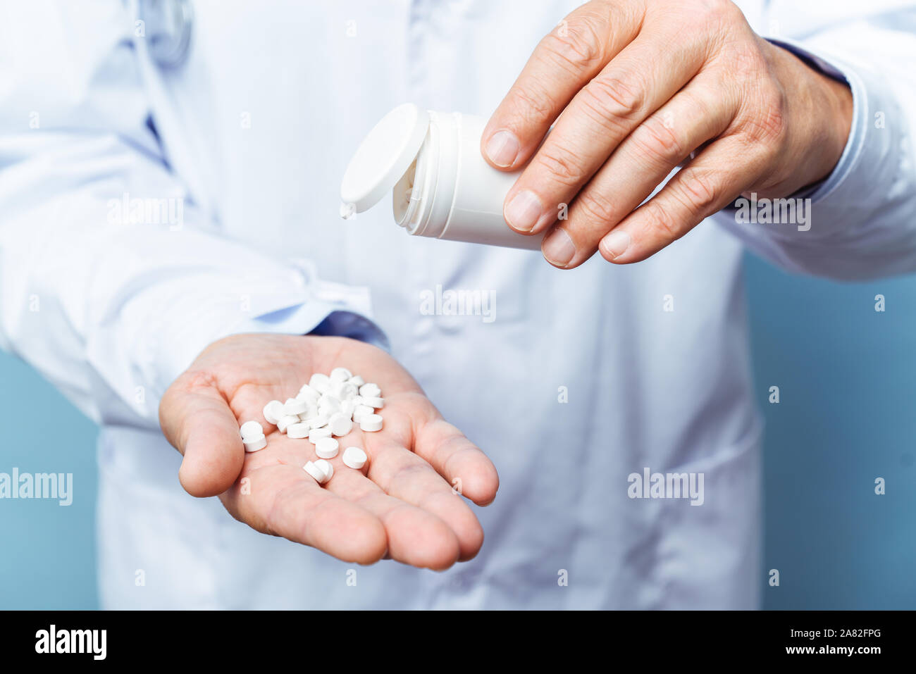 doctor holding bottle of pills on white background. The concept of ...