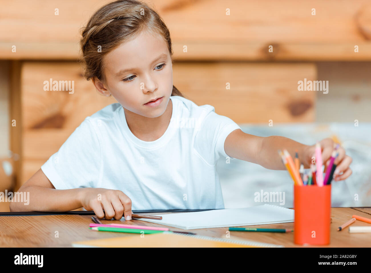 selective focus of cute kid taking color pencils Stock Photo - Alamy