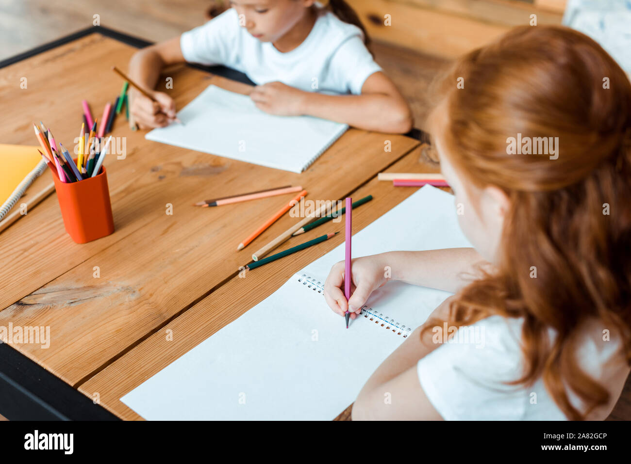 selective focus of redhead kid drawing with cute child Stock Photo - Alamy