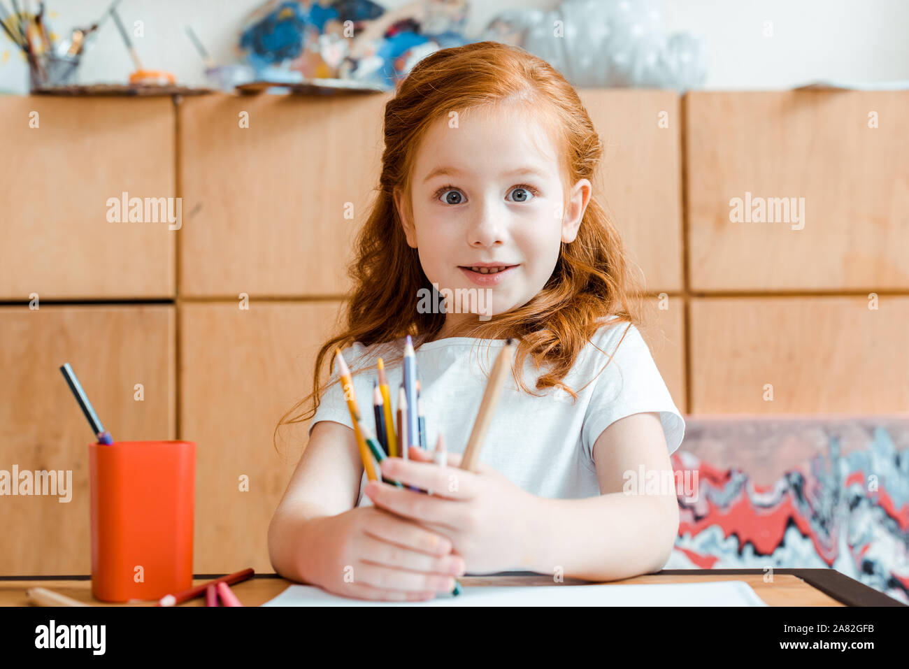 Holding colourful pencils hi-res stock photography and images - Alamy