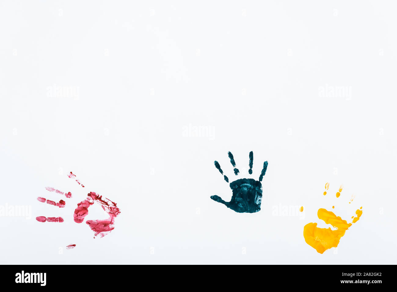 blue, red and yellow hand prints on white Stock Photo - Alamy