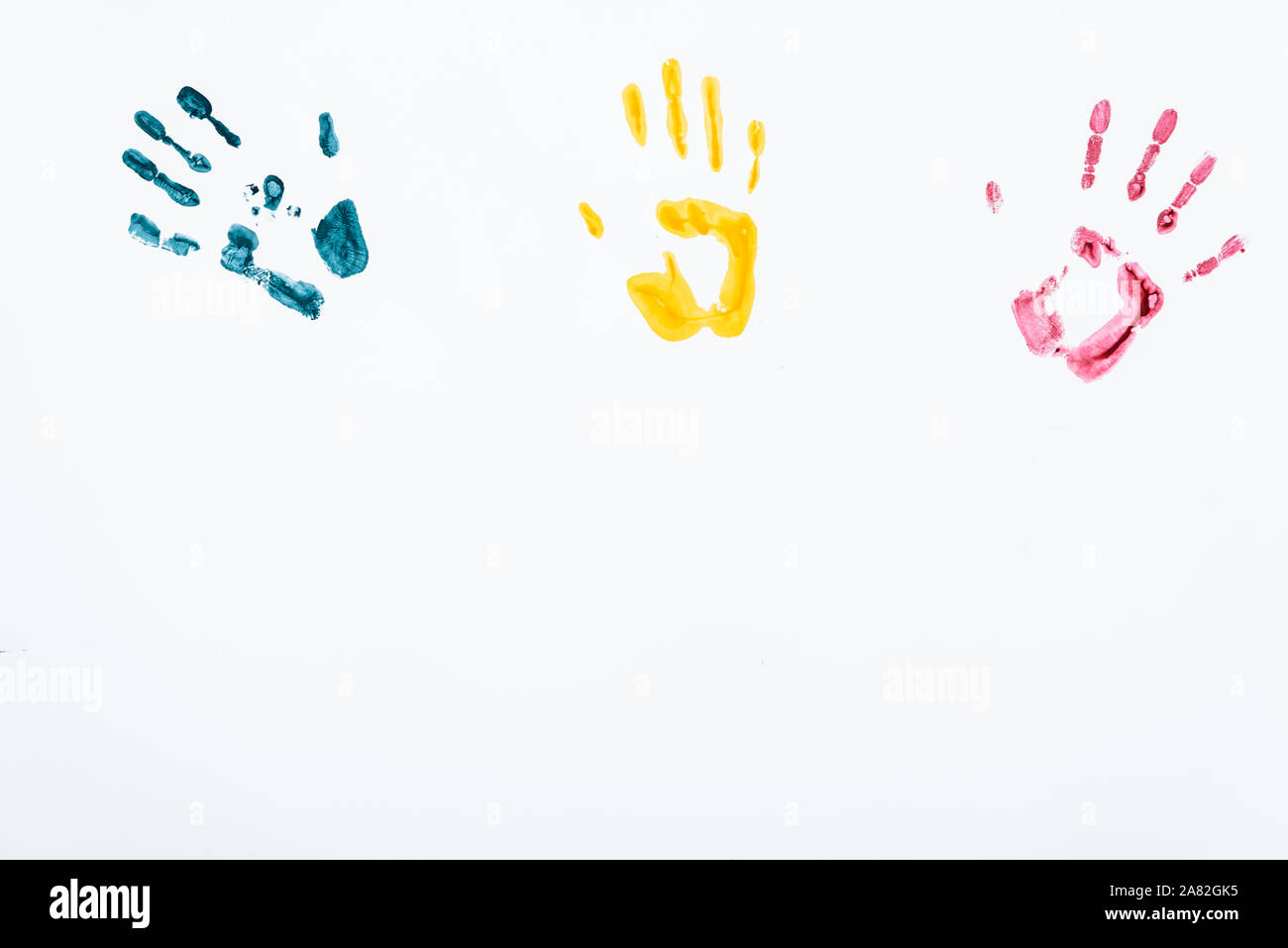 blue, yellow and red hand prints on white Stock Photo - Alamy