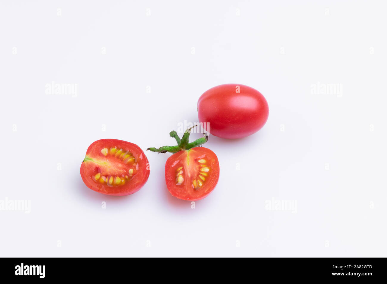 Grape or cherry tomato branch. Pile of red grape tomatoes isolated on ...