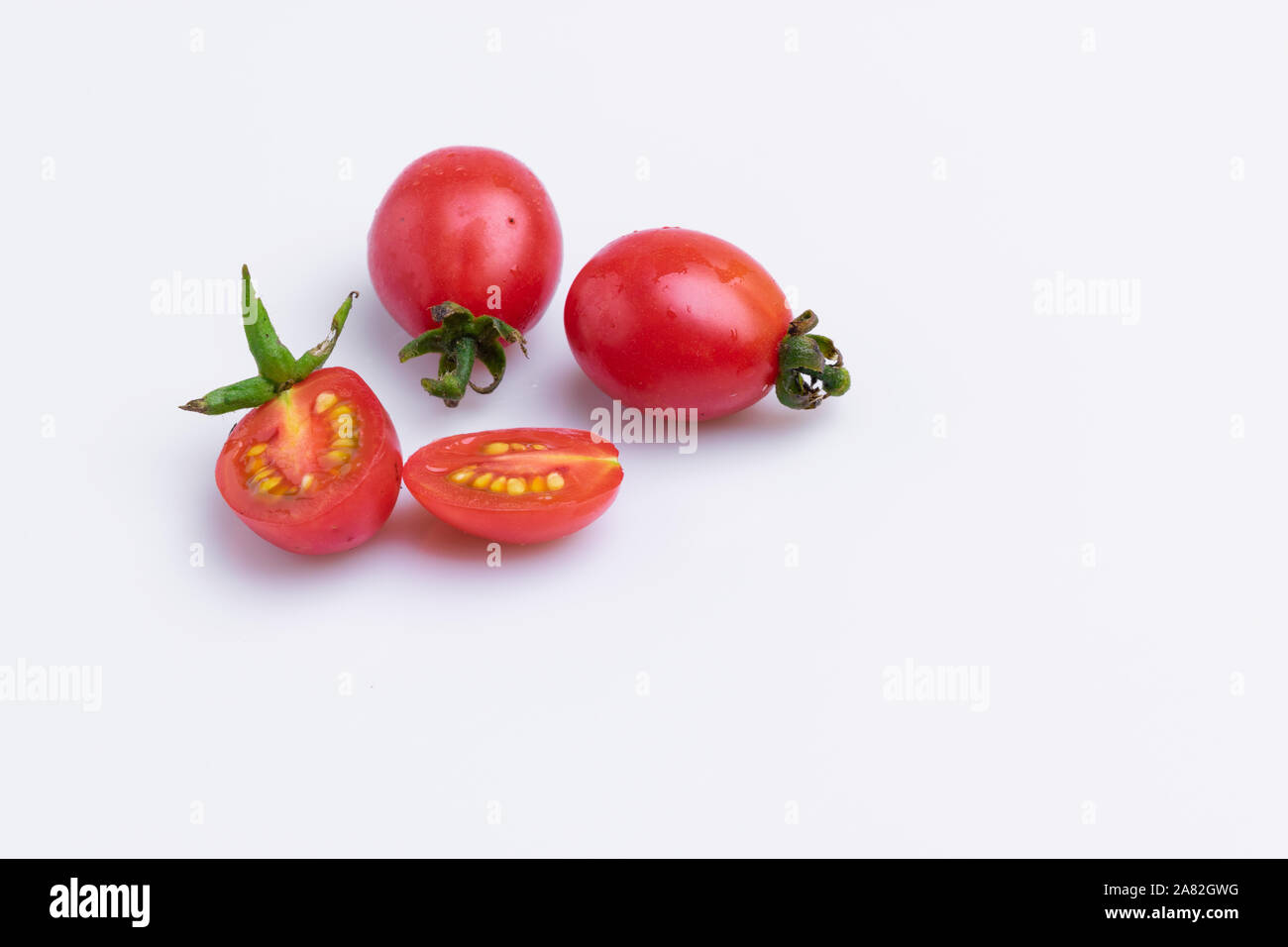 Grape or cherry tomato branch. Pile of red grape tomatoes isolated on ...
