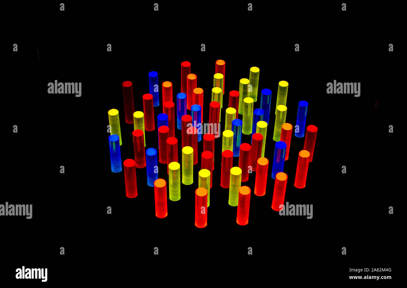 colored acrylic pegs are illuminated when placed in this grid that is ...