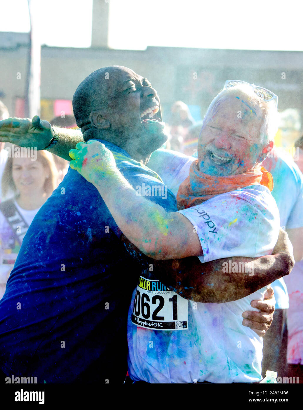 Colorful hug at color run race Stock Photo - Alamy