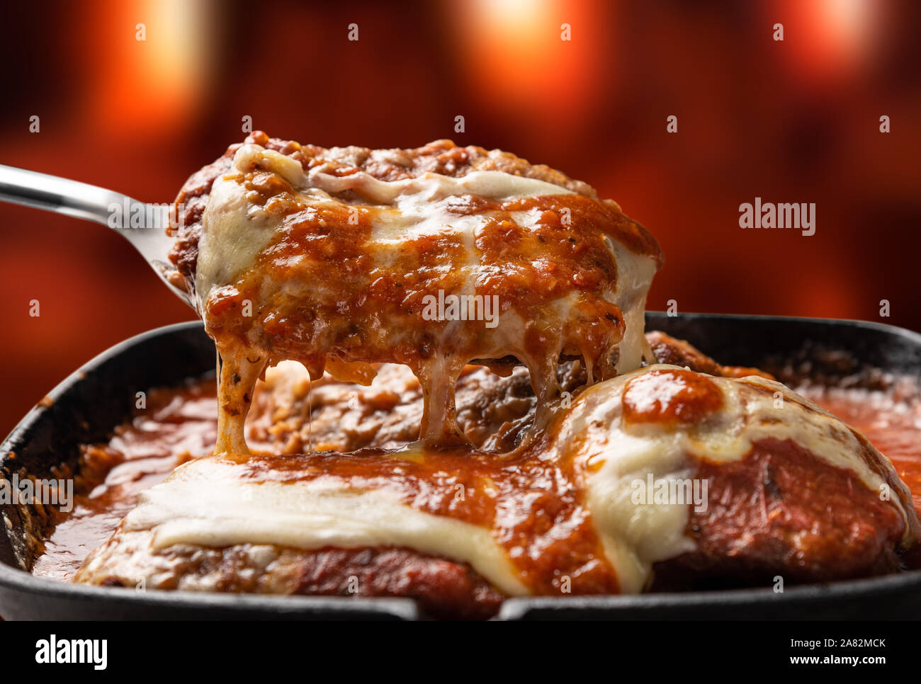 Parmegiana Steak isolated also known as Filet Parmegiana in a black ...