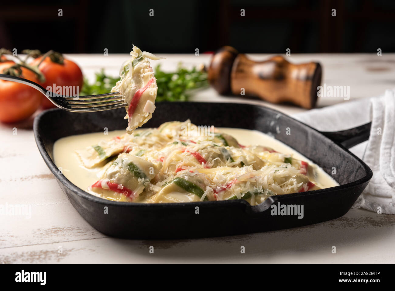 Handmade color ravioli pasta; Multi-colored ravioli pasta in a black ...