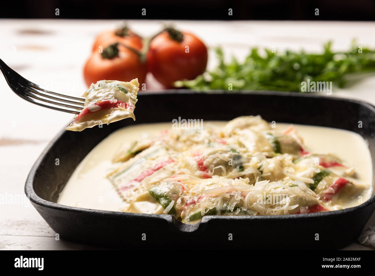 Handmade color ravioli pasta; Multi-colored ravioli pasta in a black ...