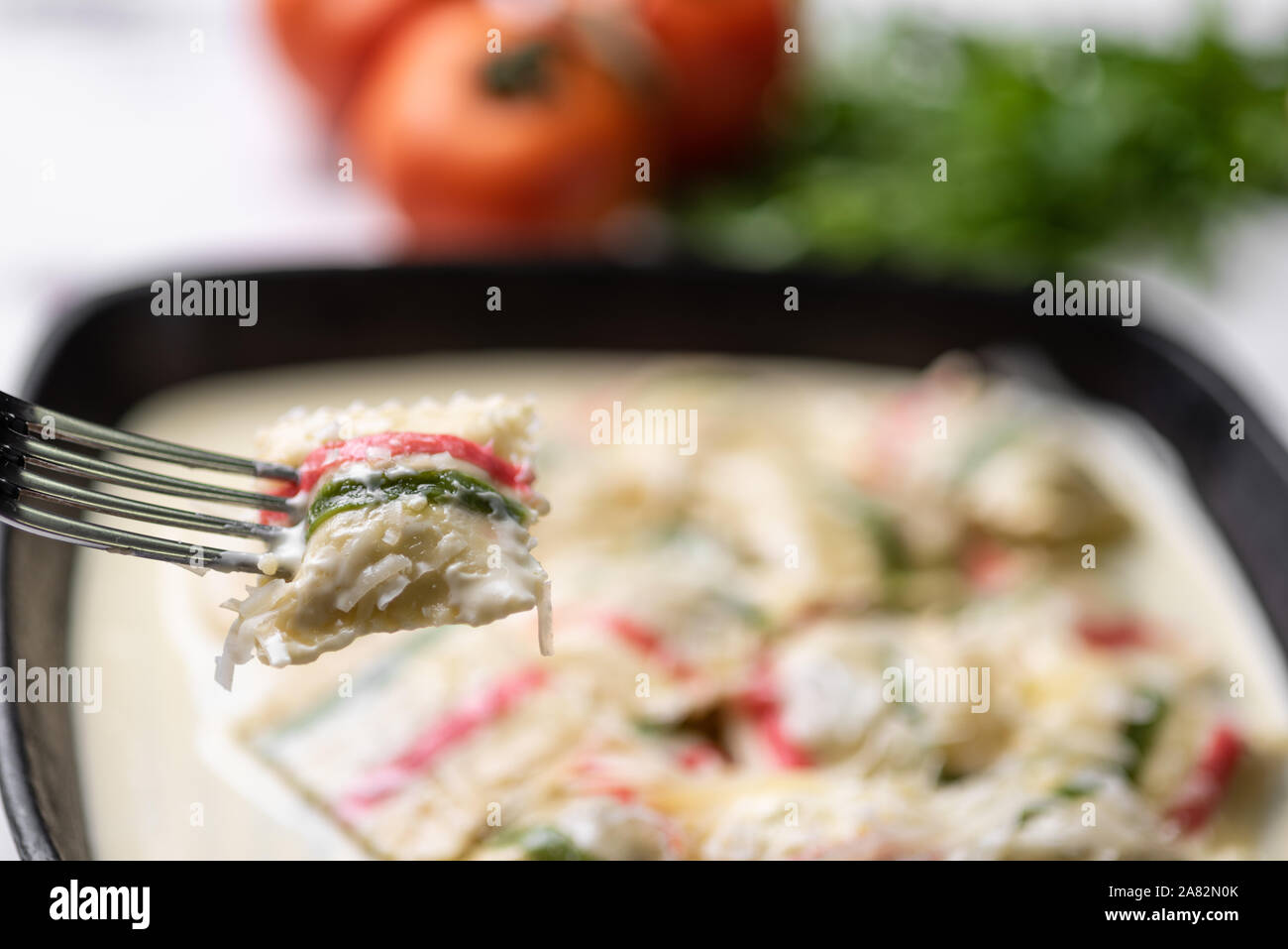 Handmade color ravioli pasta; Multi-colored ravioli pasta in a black ...