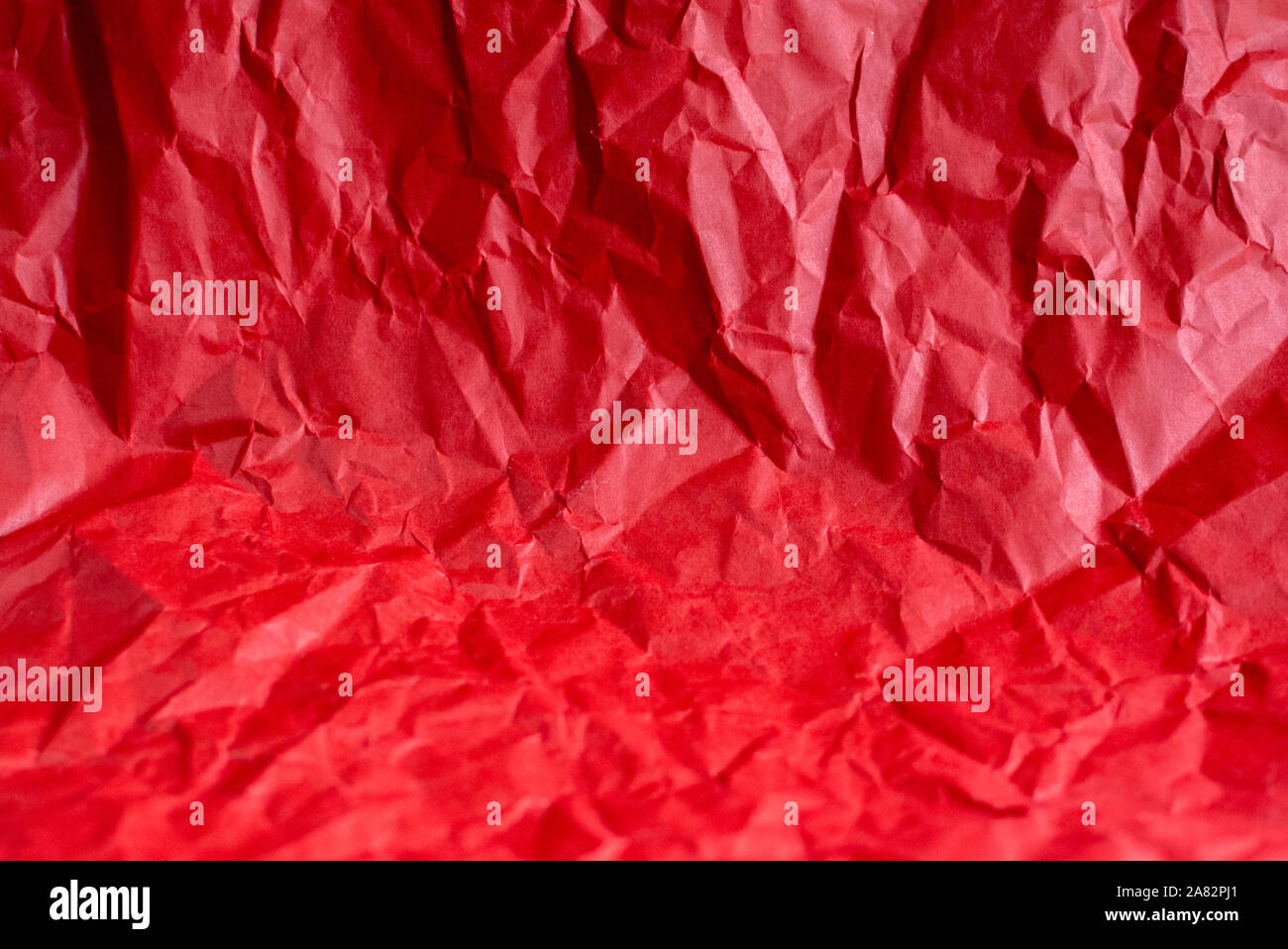 crumpled red paper makes an interesting background Stock Photo - Alamy