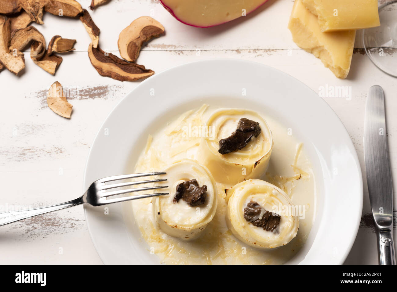 Homemade rondelli with four cheese and mushuroom sauce in white plate ...