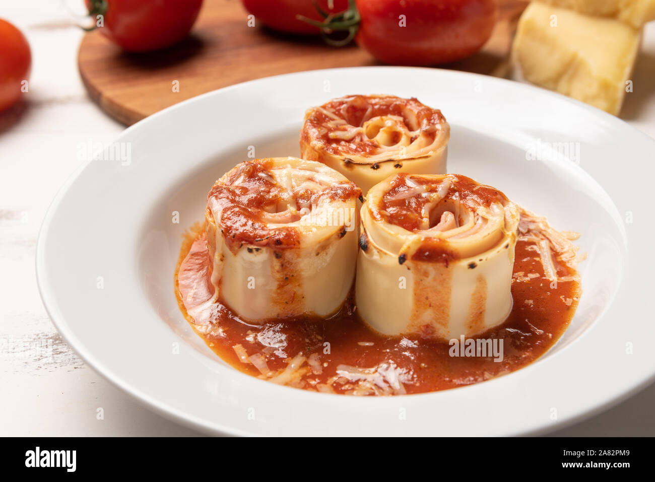 Traditional Italian Rondelli pasta with tomato sauce on rustic white ...