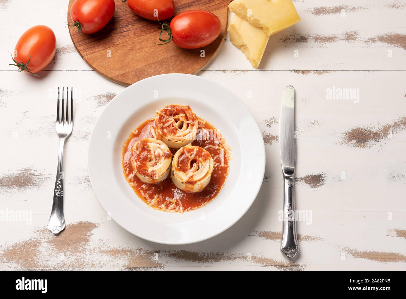 Traditional Italian Rondelli pasta with tomato sauce on rustic white ...
