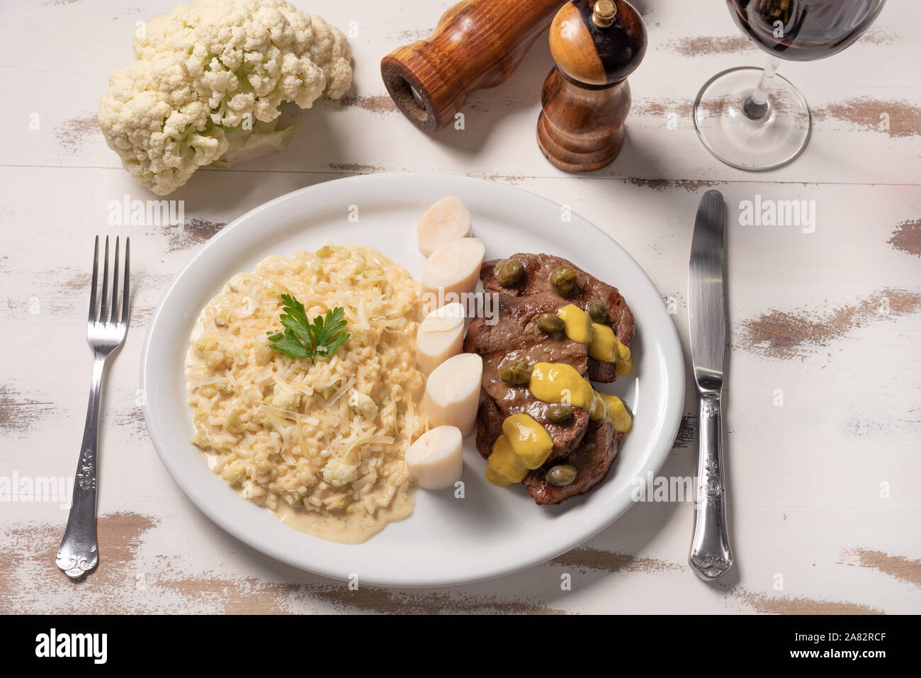 Risotto with filet mignon. Risoto and beef with capers and mustard in a ...
