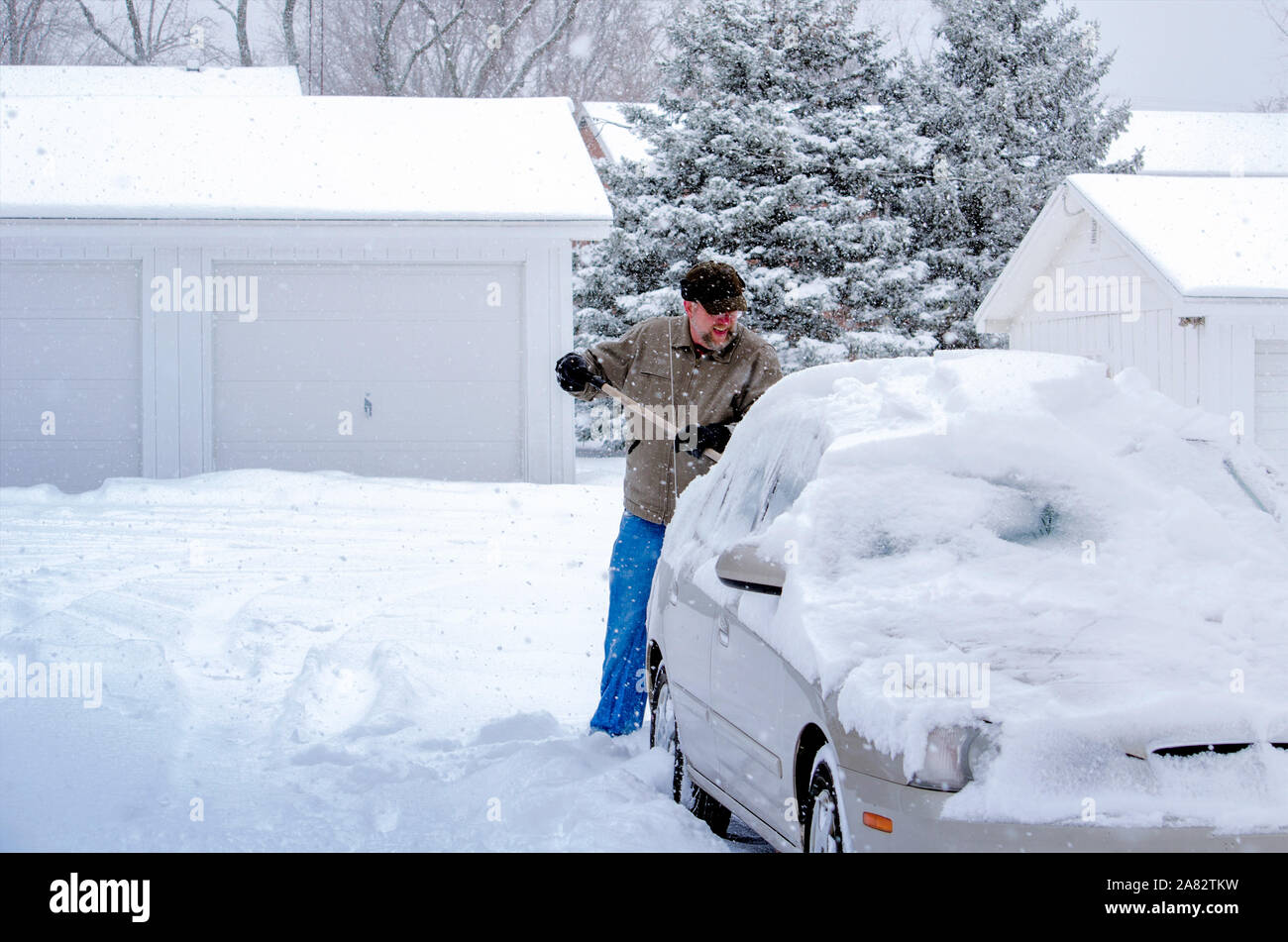 Man cleaning car covered by snow hi-res stock photography and images ...