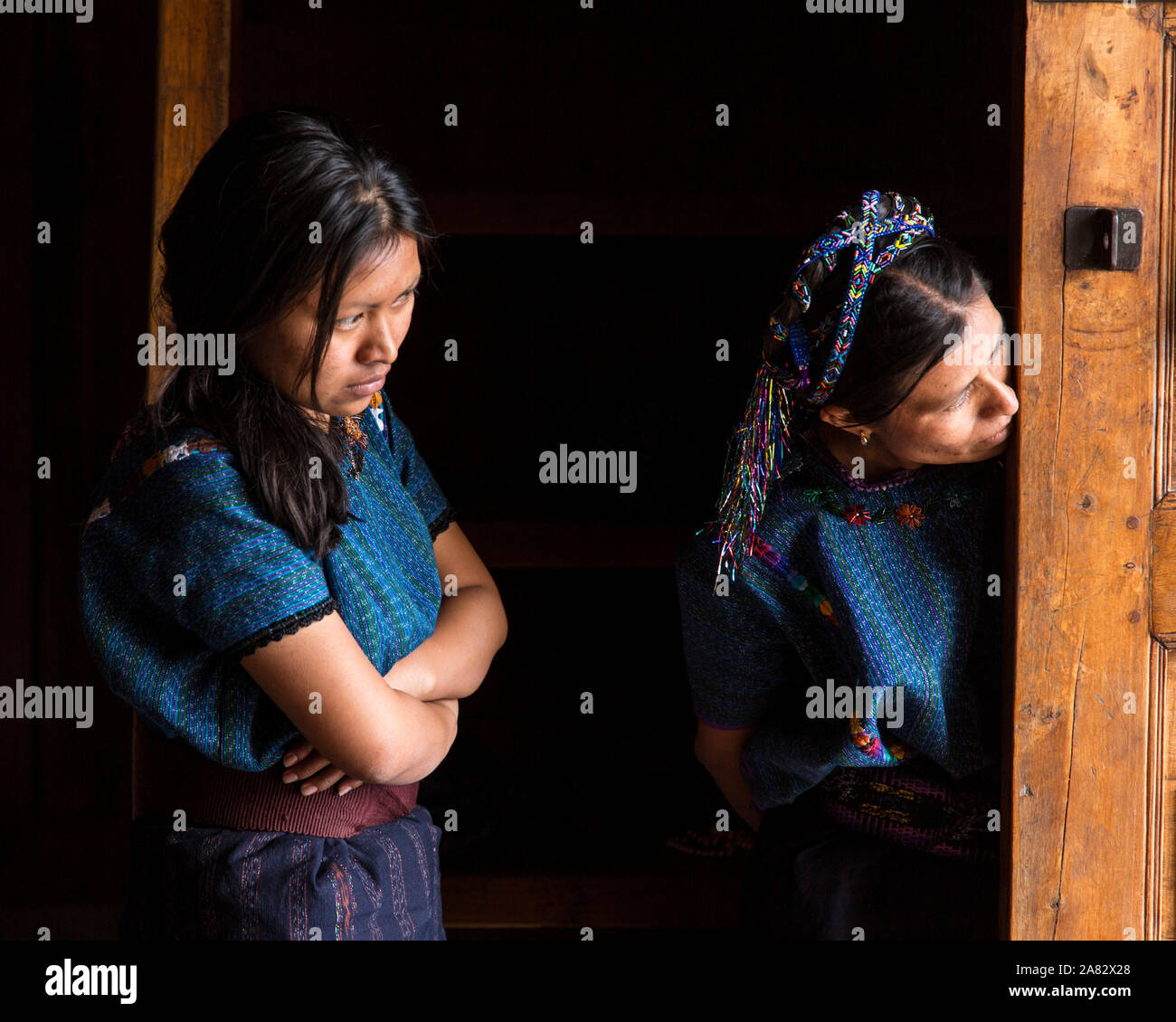 Two Mayan women peering out the door of the Saint Anthony of Padua ...