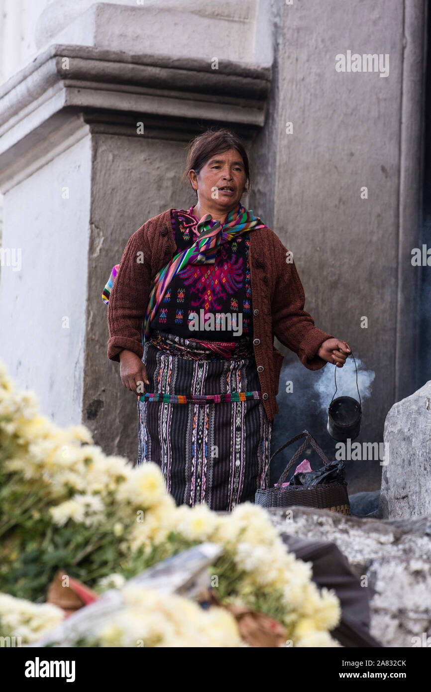 A Quiche Mayan woman in traditional dress burns incense to the Mayan ...