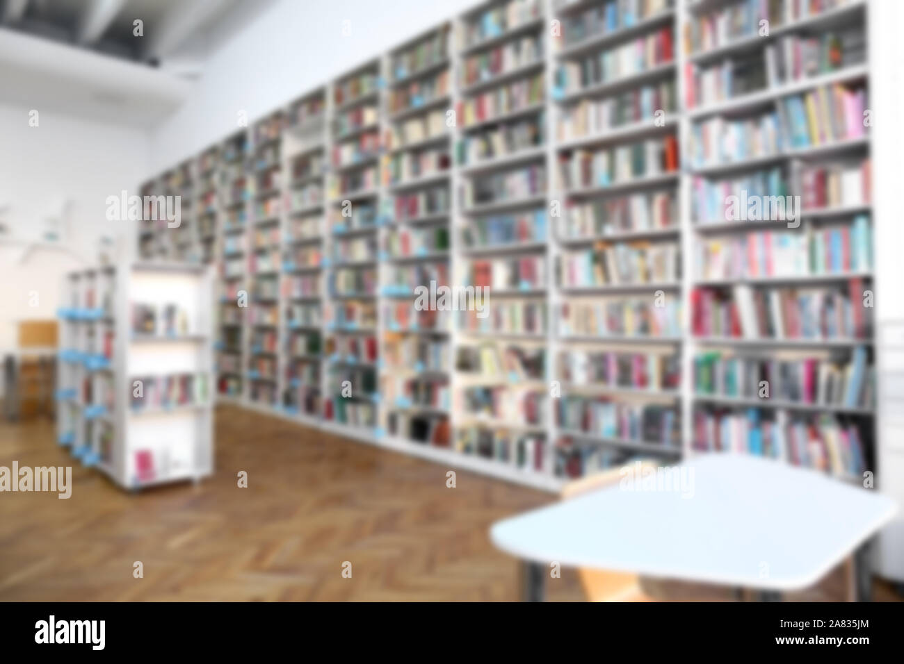 Many books on shelves in modern library, blurred view Stock Photo - Alamy