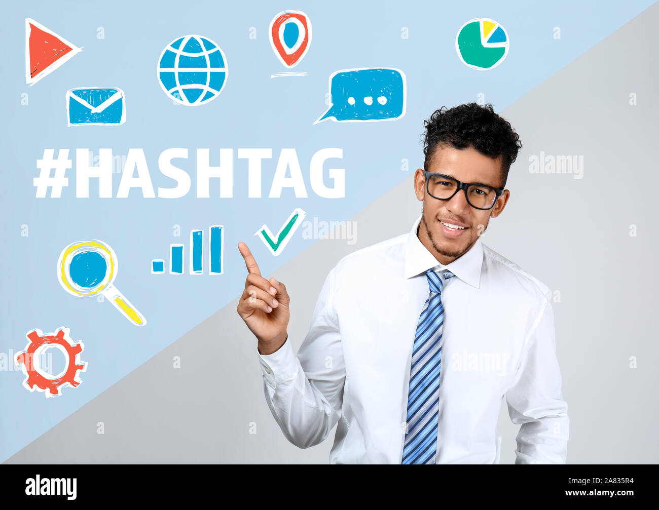 African-American businessman pointing at hashtag and digital icons ...