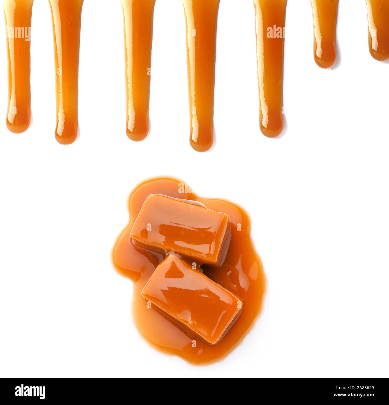 Tasty caramel candies and stains on white background Stock Photo - Alamy