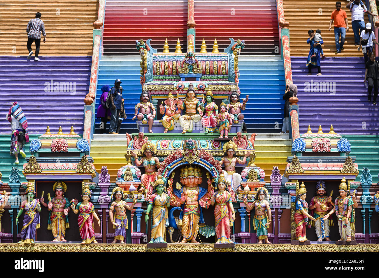(Selective focus) Representation of Hindu gods and tourists climbing a ...