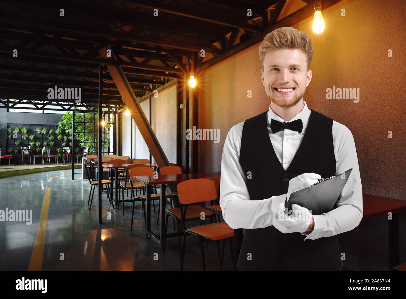 Handsome waiter in modern cafe Stock Photo - Alamy